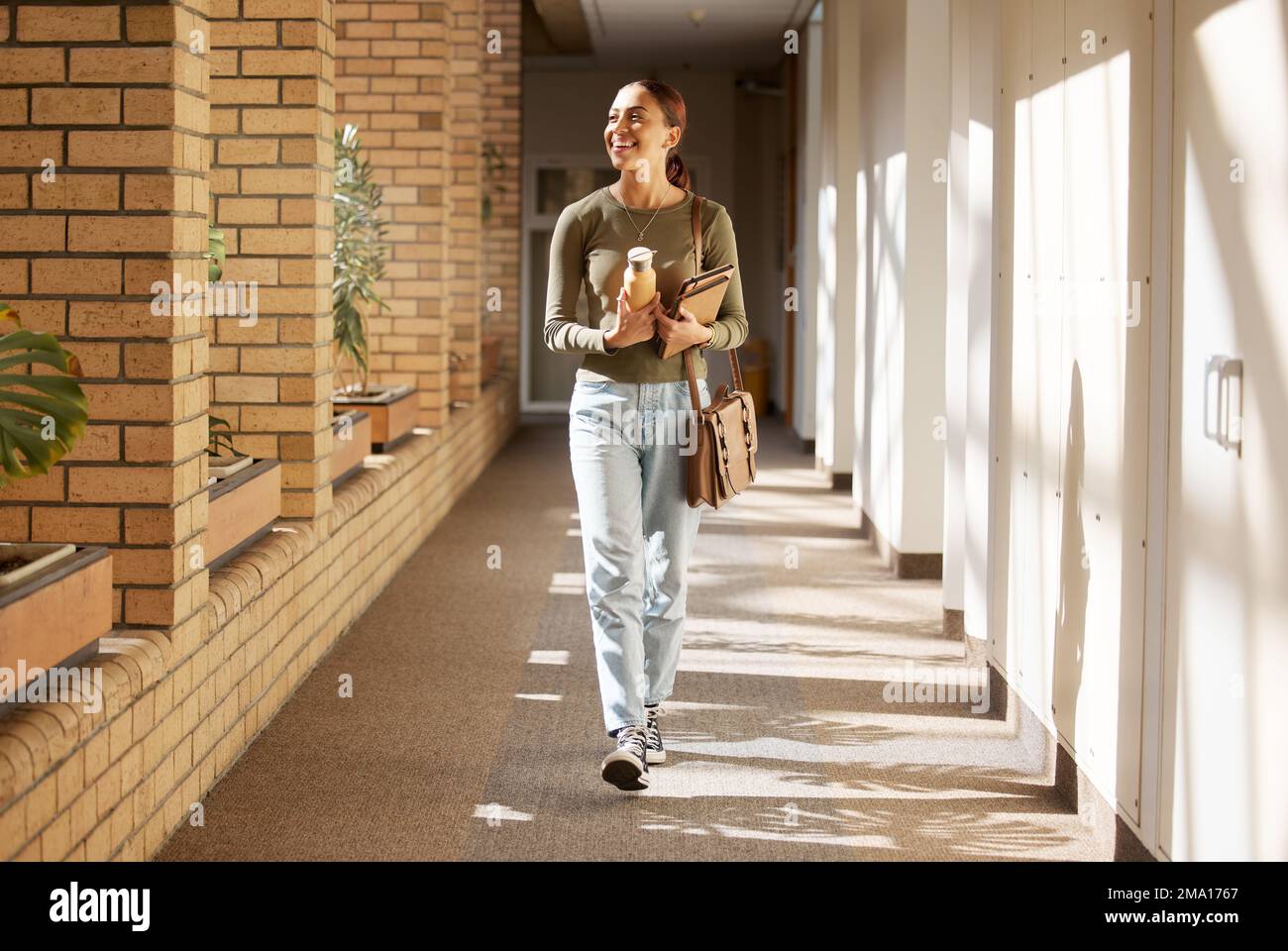 Woman, student and university hallway with a person walking ready for ...