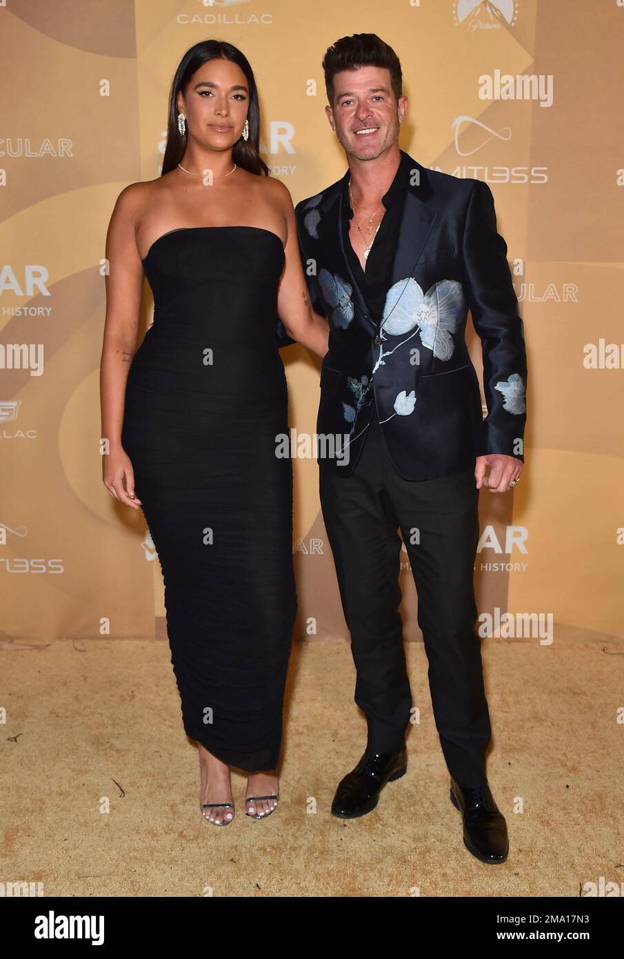 April Love Geary, left, and Robin Thicke arrive at the amfAR Gala Los ...