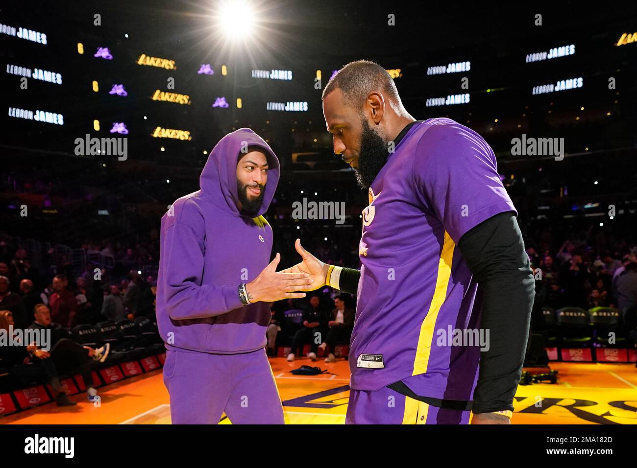 Los Angeles Lakers' Anthony Davis, left, greets forward LeBron James (6 ...