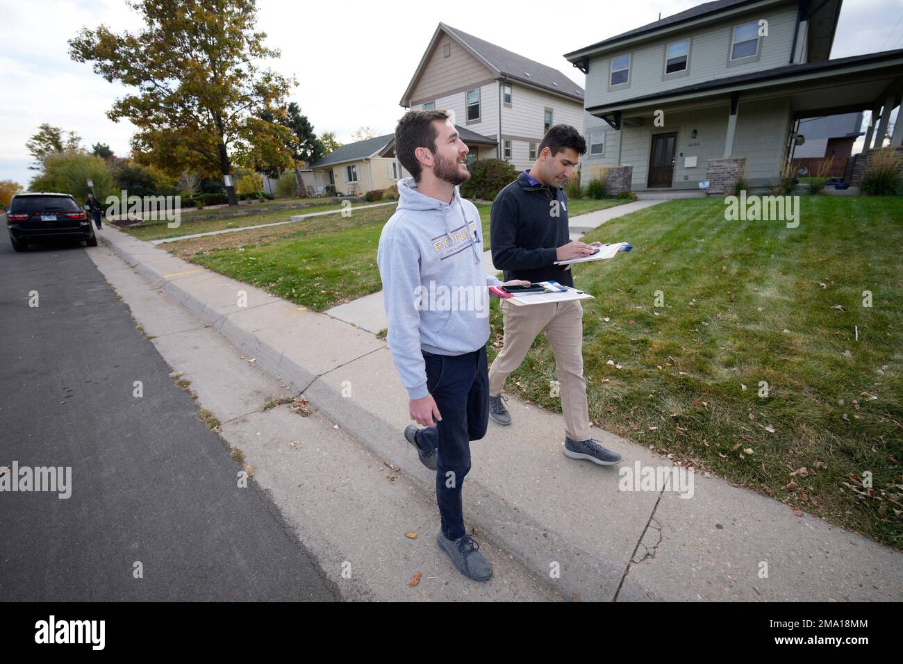 Vote canvassers Zach Martinez, front, and Joshua Posner check their ...