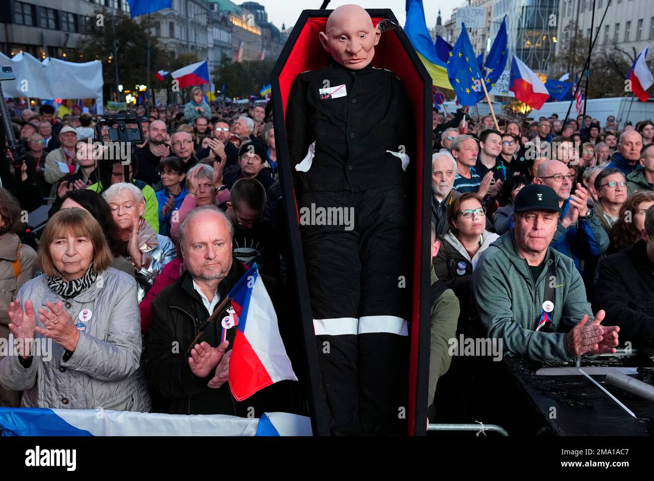 People clap their hands by a statue depicting Russian President ...