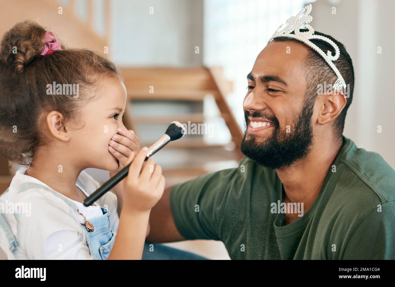 You look so funny, Daddy. a little girl putting makeup on her father ...