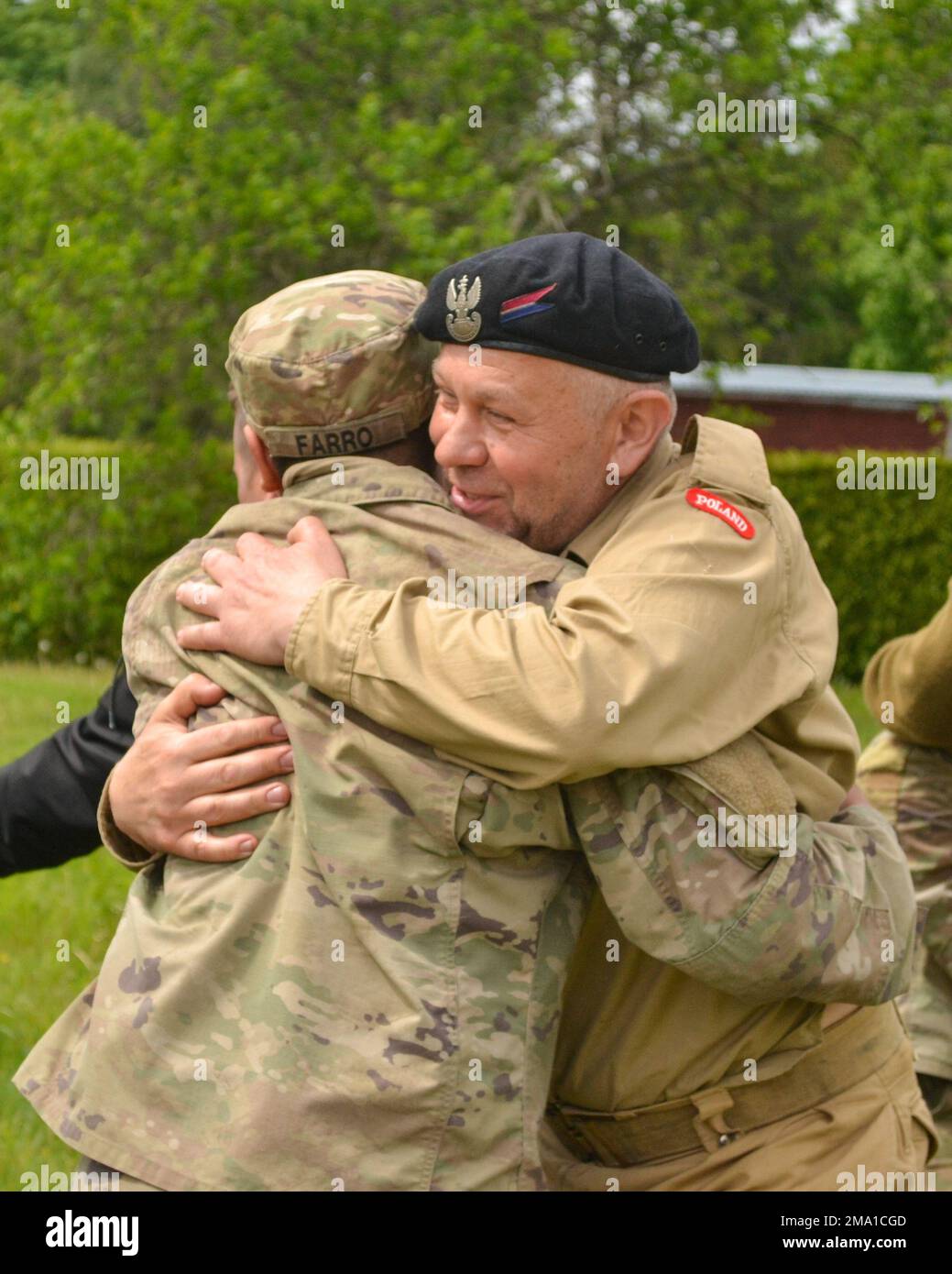 A Polish reenactor hugs a U.S. Soldier assigned to 1st Battalion, 68th ...