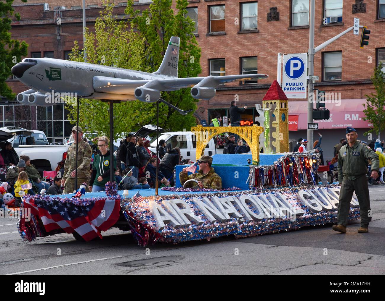 The Air National Guard leadership walk next to their float and wave ...