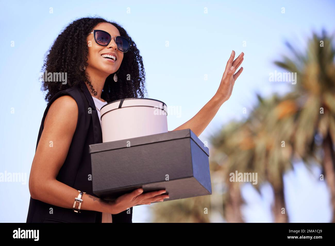 Black woman, shopping and gifts with smile waiting for lift, pickup or ...