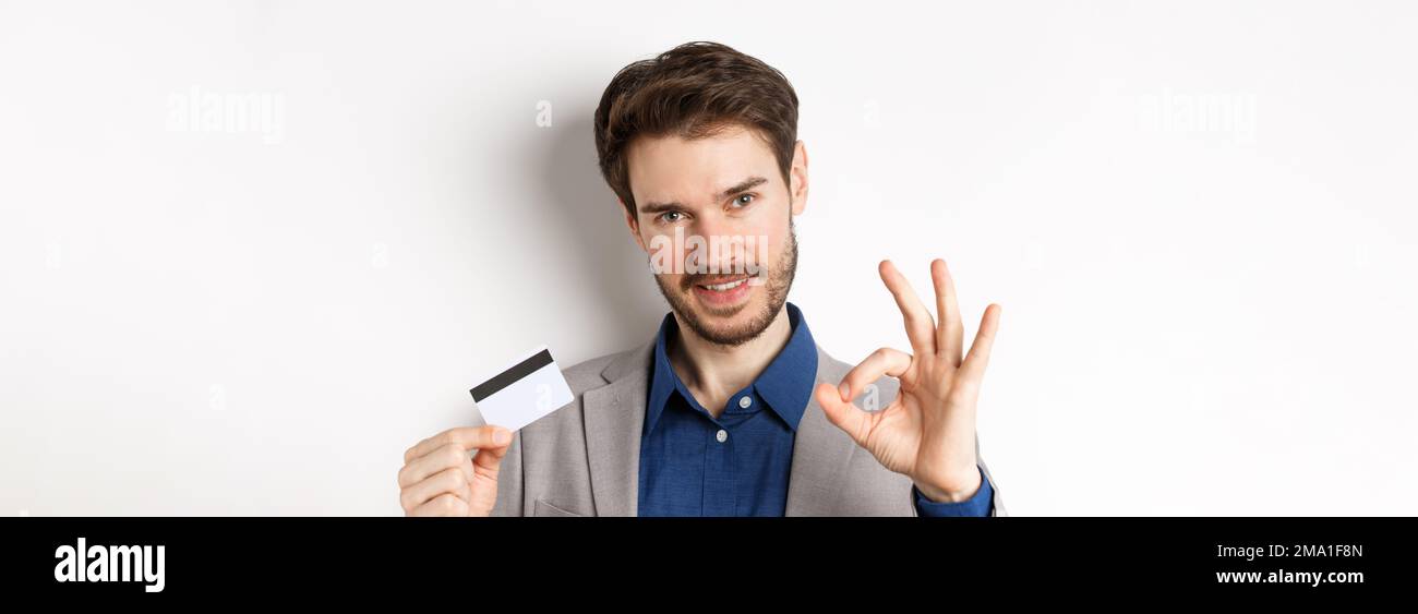 Shopping. Handsome man showing okay sign and plastic credit card, all ...