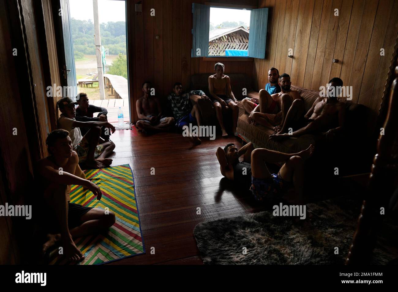 Youth fishermen watch a soccer game on the tv in San Raimundo, in ...