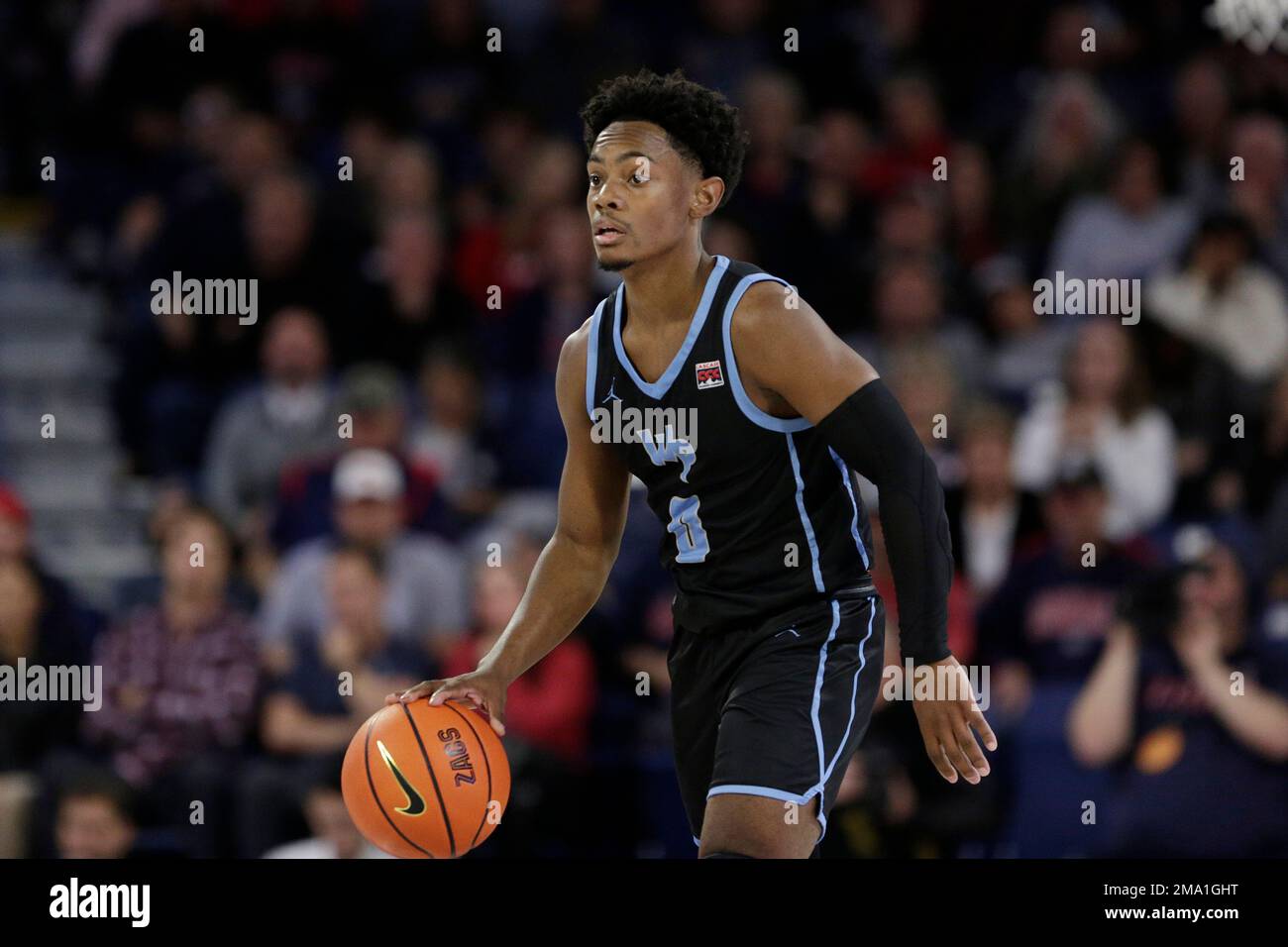 Warner Pacific guard Isaac Etter controls the ball during the first ...