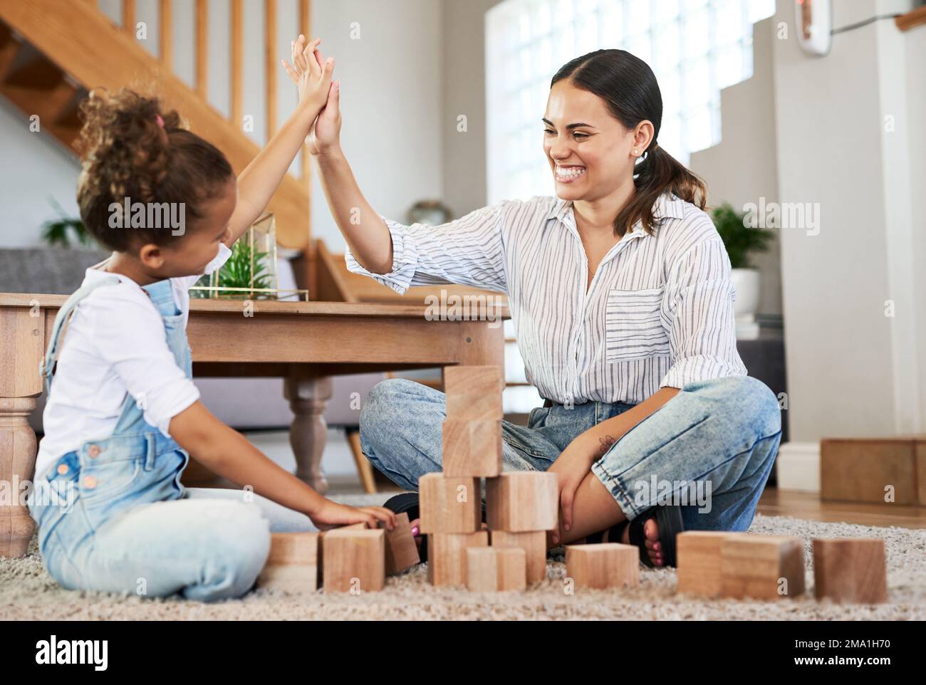 Build a stronger bond by playing with your children. a mother and her daughter giving each other ...