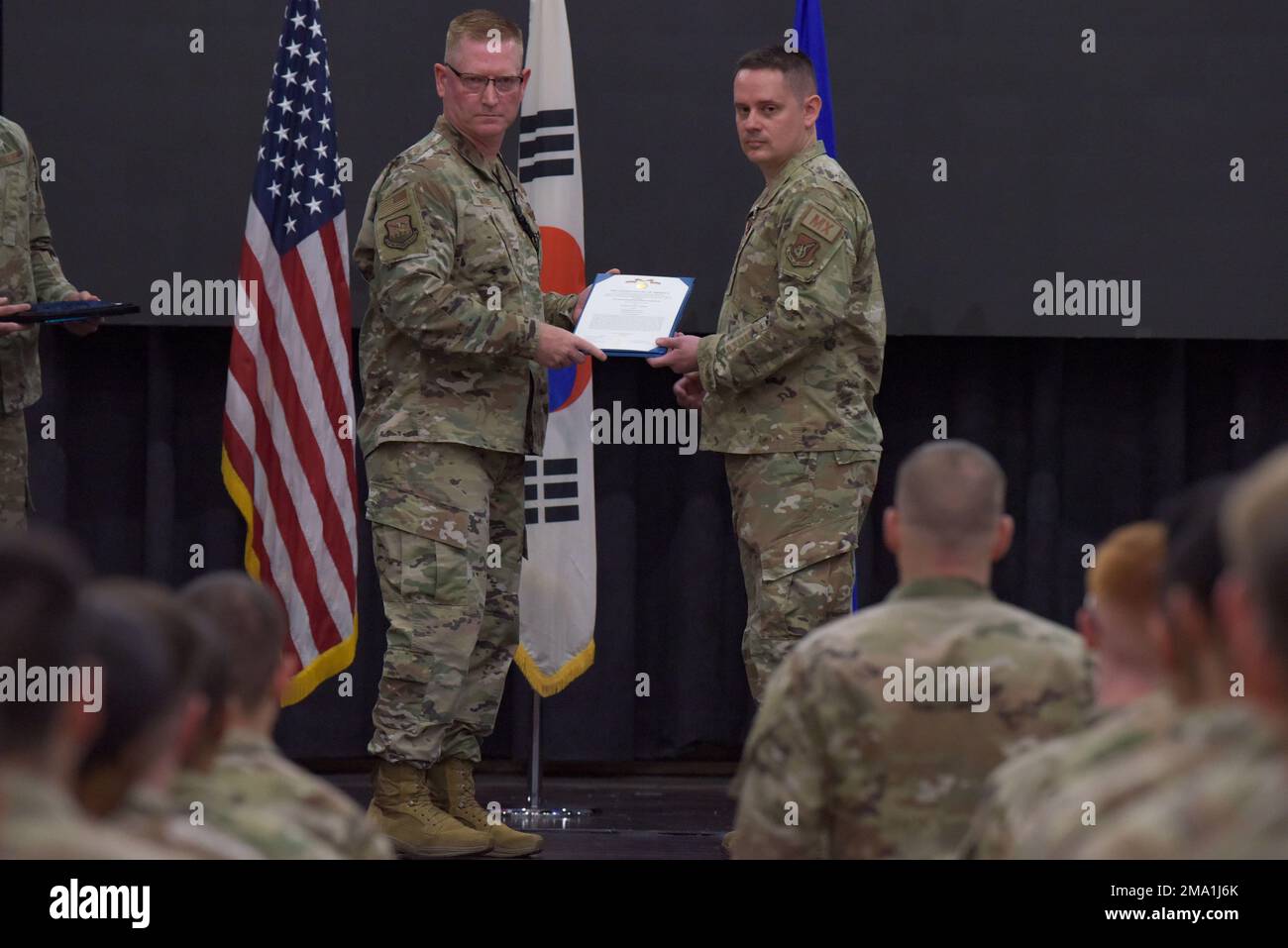 Col. Brian Moore, left, 51st Maintenance Group commander, presents a ...
