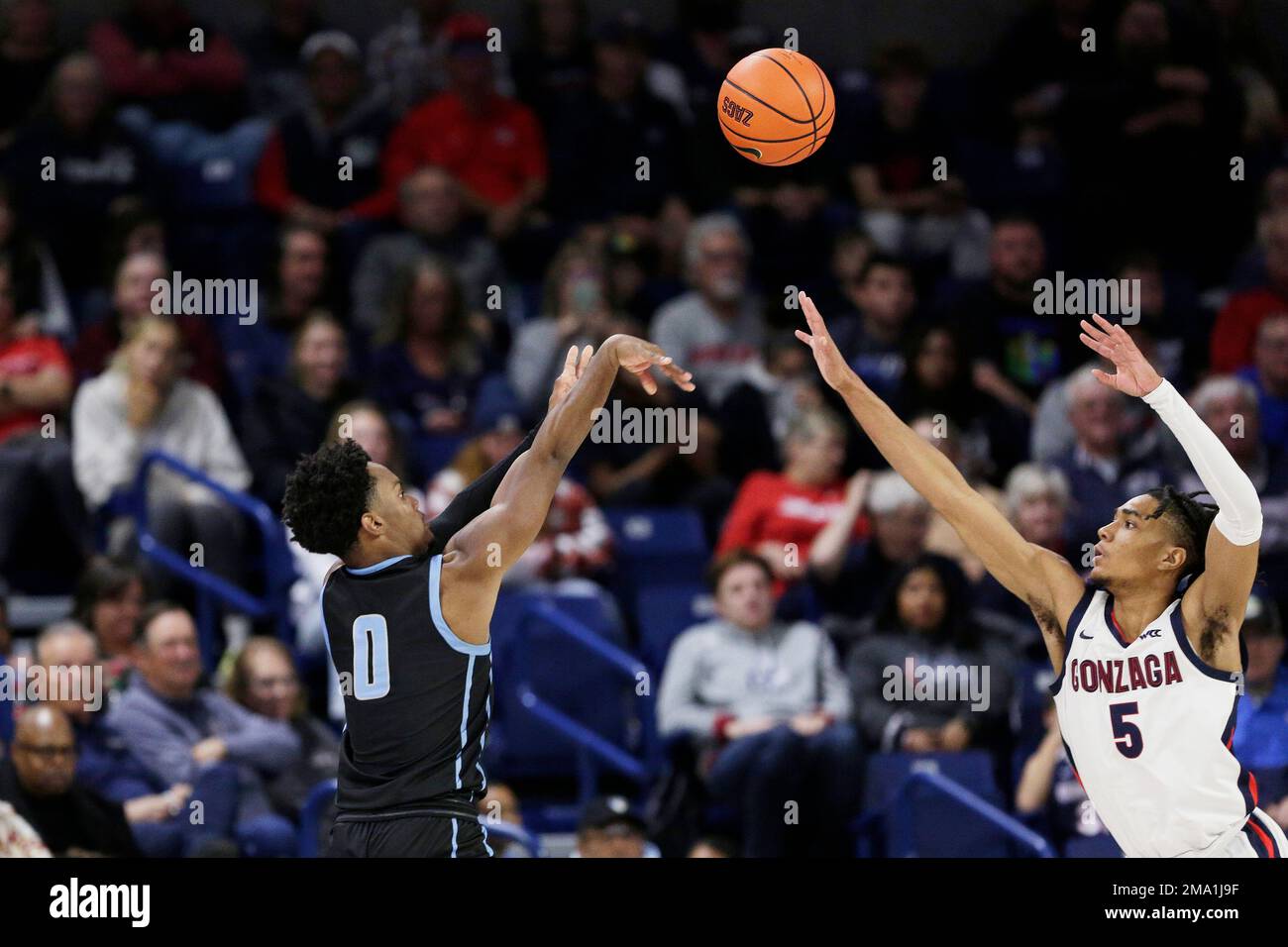Warner Pacific guard Isaac Etter (0) shoots over Gonzaga guard Hunter ...