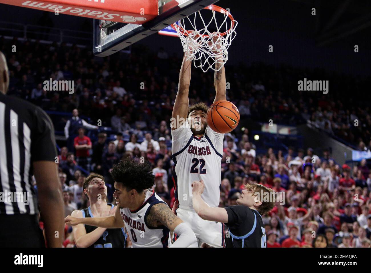 Gonzaga forward Anton Watson, center, dunks between teammate Julian ...