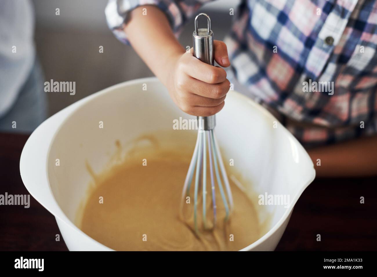 A lesson on consistency. an unrecognizable girl mixing ingredients and ...