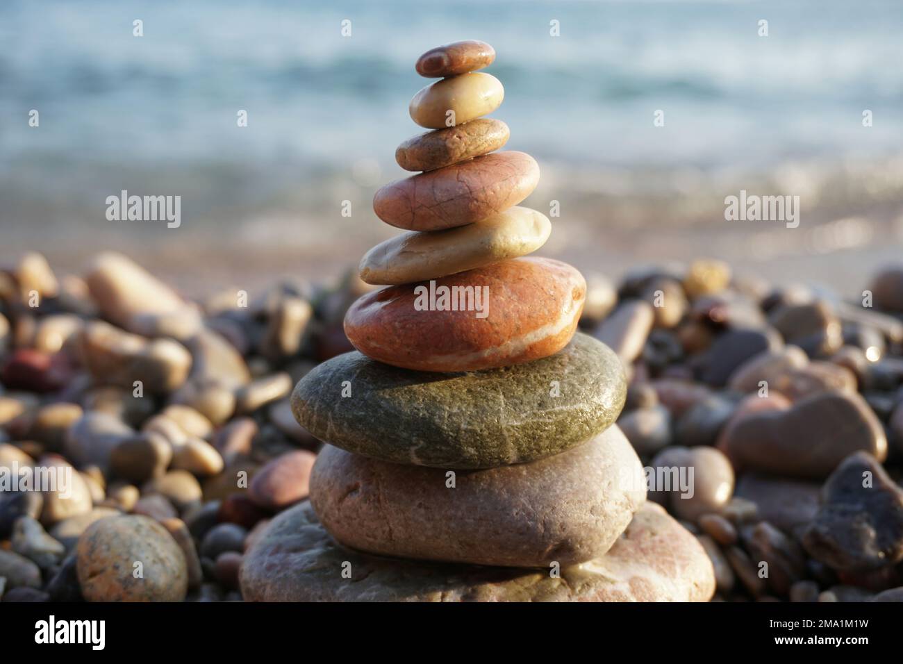 A close-up shot of cairn on the beach with the sea in the background ...