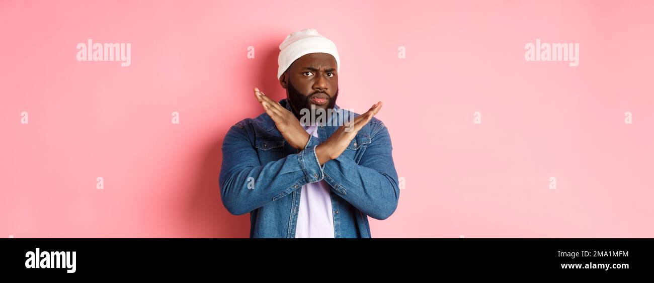 Disappointed Black man, staring at camera displeased and frowning ...