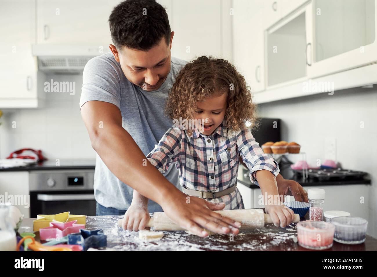 Dad helps me make it perfect. a sweet little girl baking with her ...