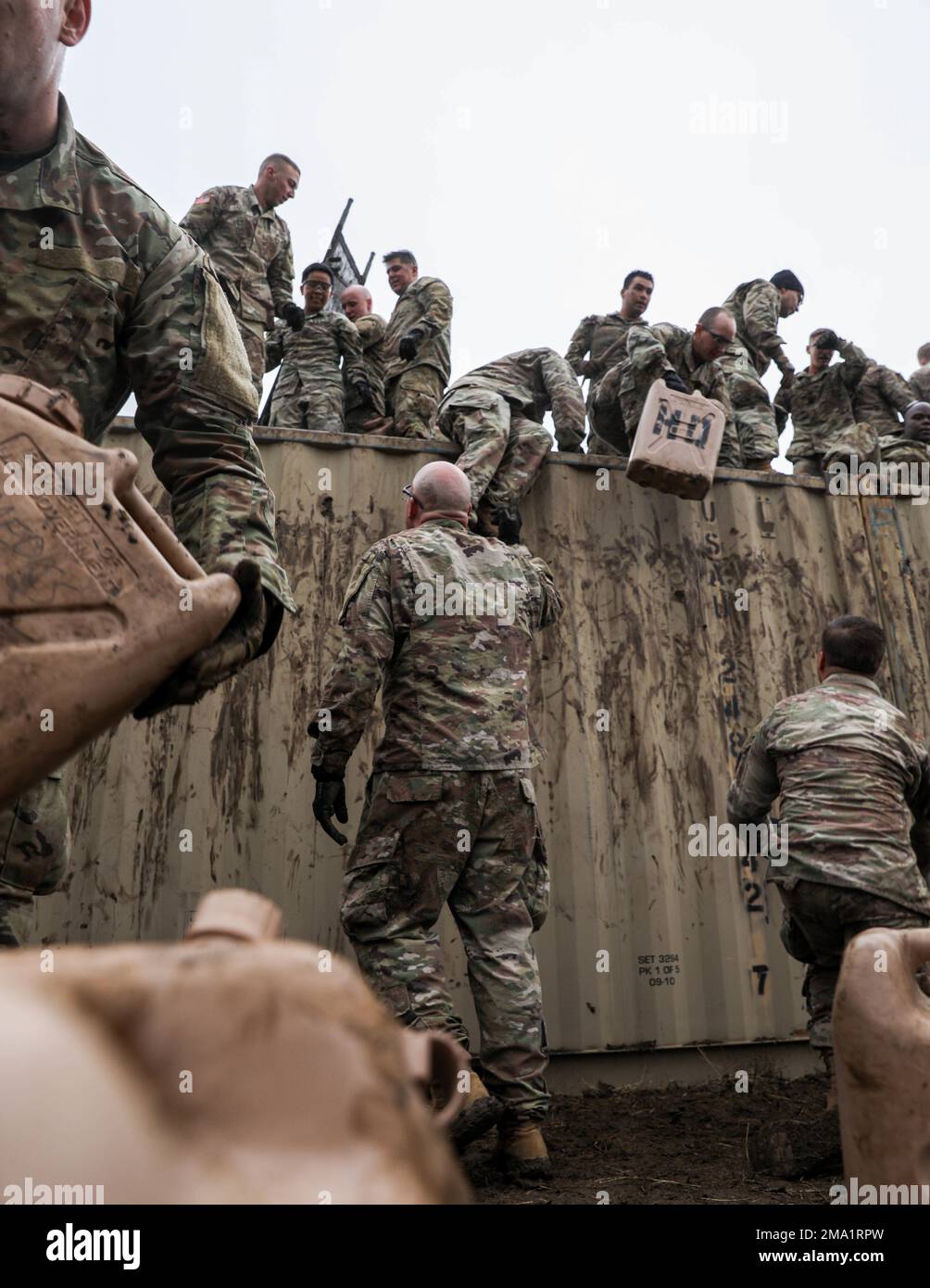 Soldiers assigned to the 4th Infantry Division carry five-gallon water ...