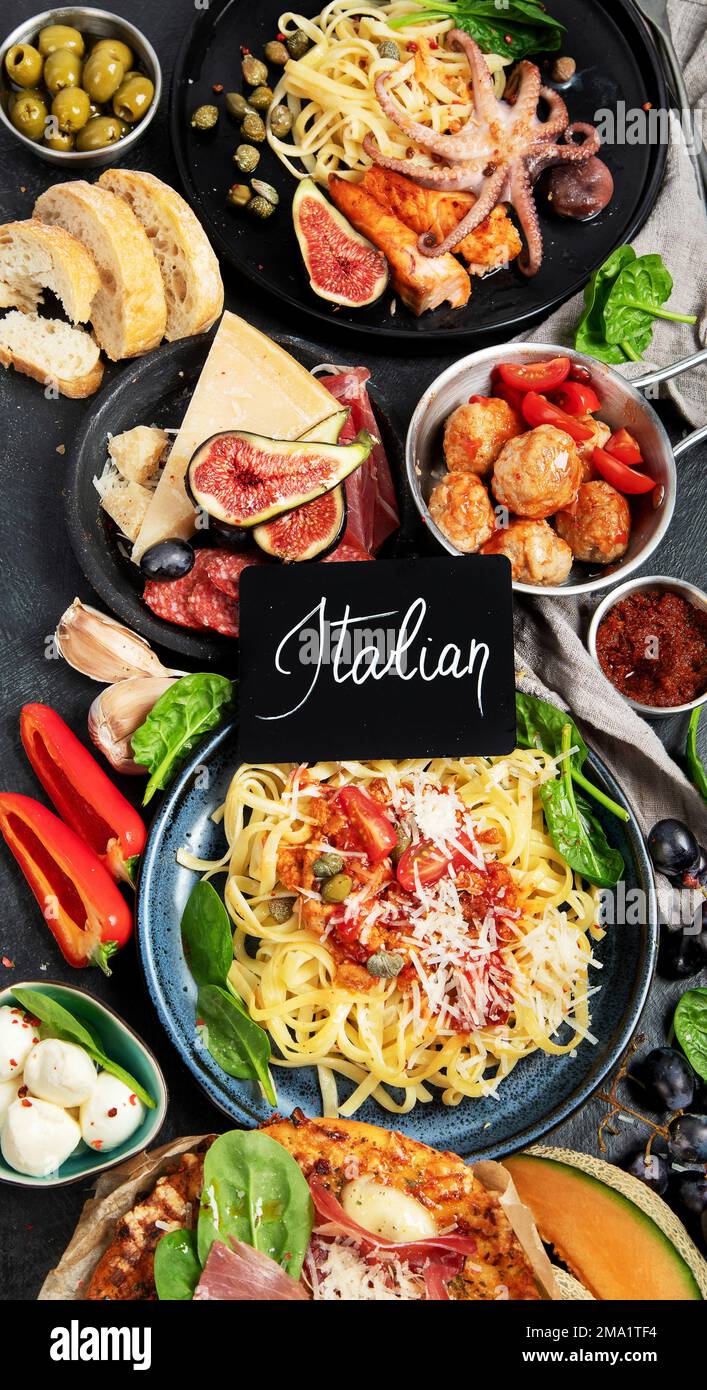 Dinner table of italian meals dishes. Pizza, pasta, antipasto on black ...