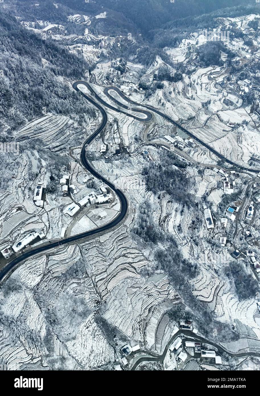 Aerial photo shows snow blanketing the mountain roads, rural fields ...