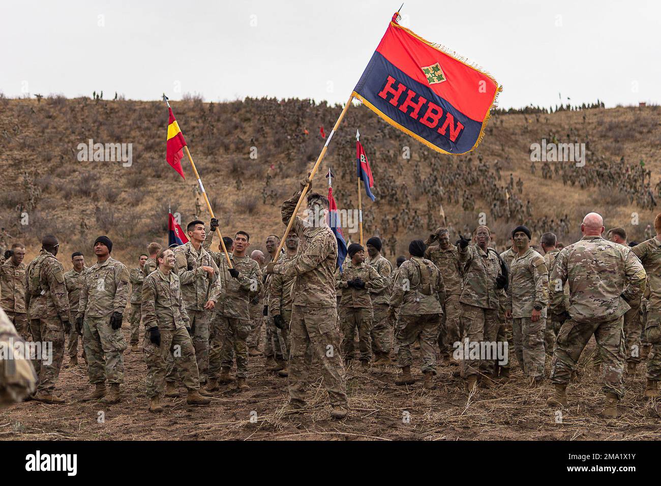 A Soldier assigned to the 4th Infantry Division, signals to the rest of ...