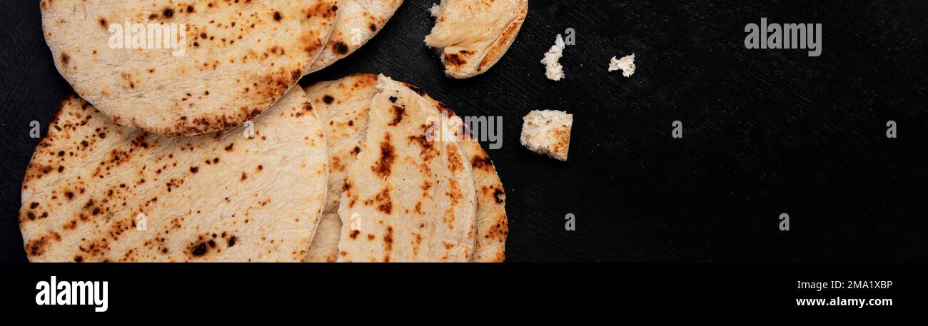 Pita bread isolated on a dark background. Traditional and typical food ...