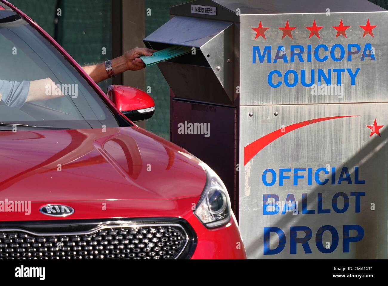 A voter casts their ballot at a secure ballot drop box at the Maricopa ...