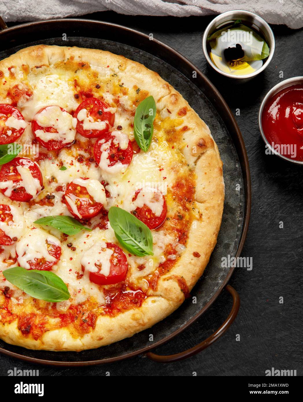 Freshly baked pizza on dark background. Tasty homemade food concept ...