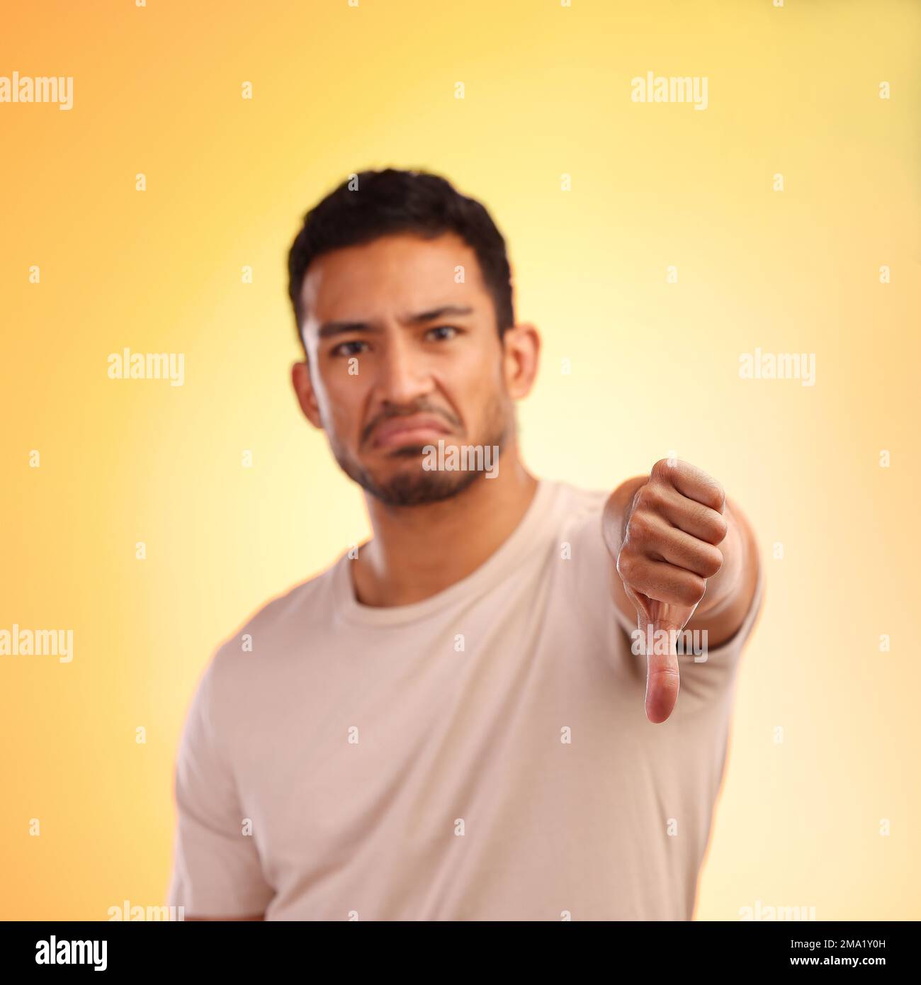 Man, thumbs down and studio portrait with sad, depressed face and ...