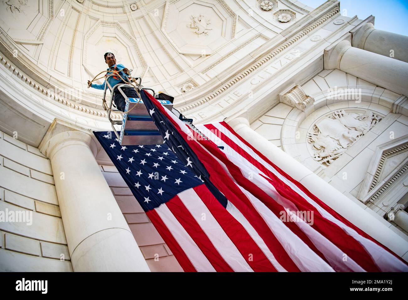 ANC Facilities Maintenance employees hang U.S. flags in the Memorial ...