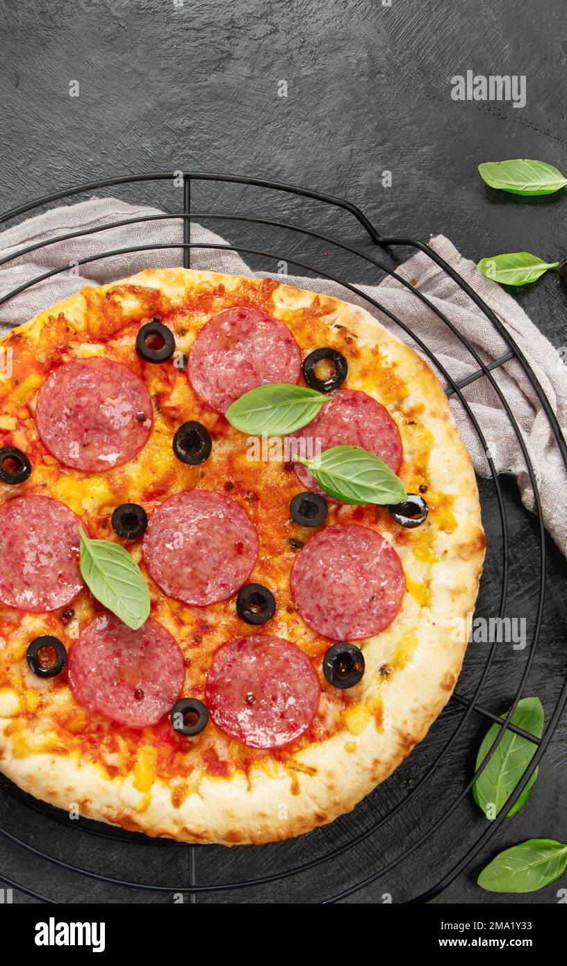 Freshly baked pepperoni pizza on dark background. Tasty homemade food ...