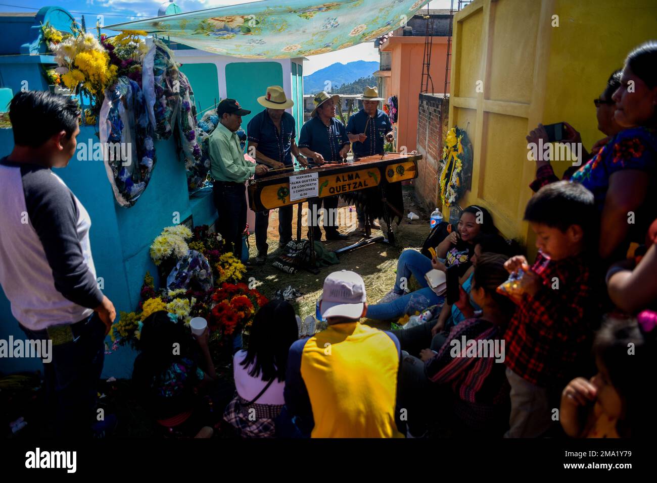 Musicians play a marimba for a family who decorated a relative's tomb ...