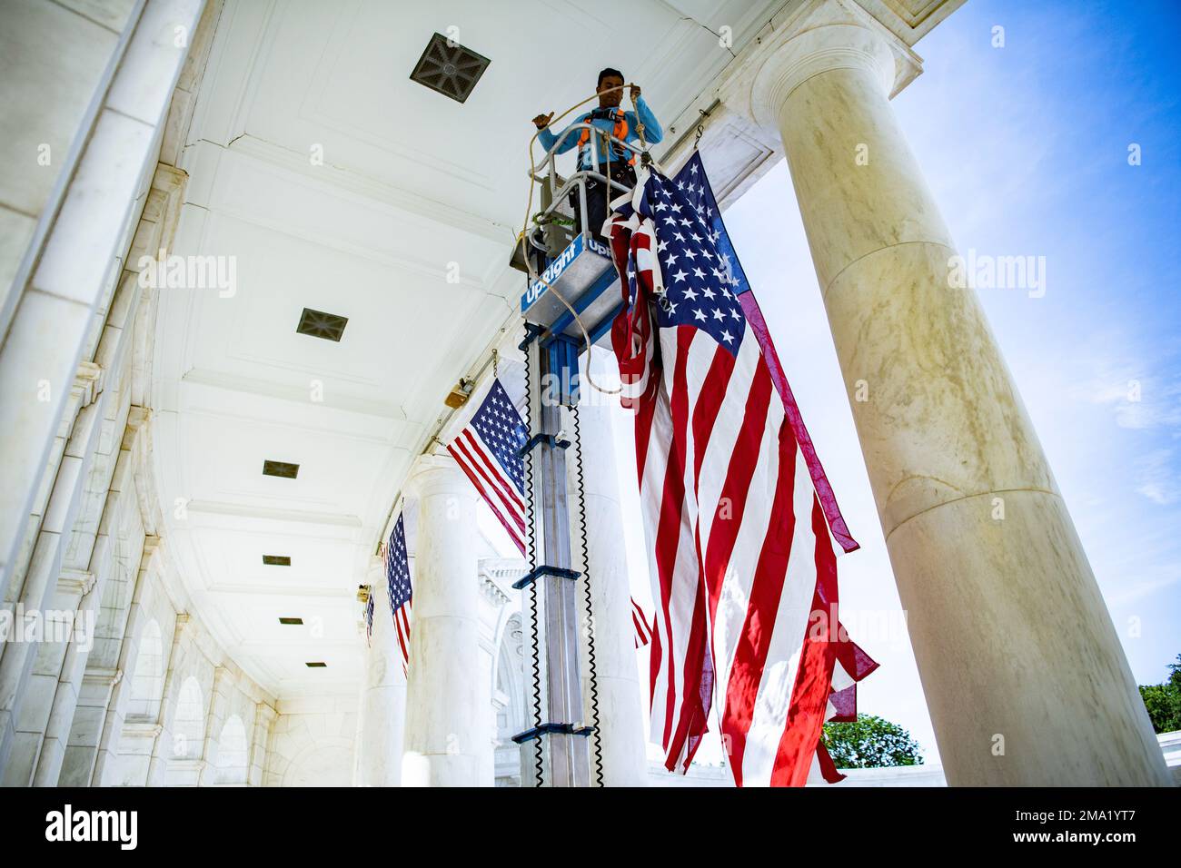 ANC Facilities Maintenance employees hang U.S. flags in the Memorial ...