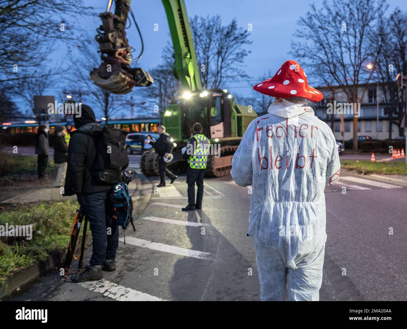 18 January 2023, Hessen, Frankfurt/Main: An activist in a white painter ...