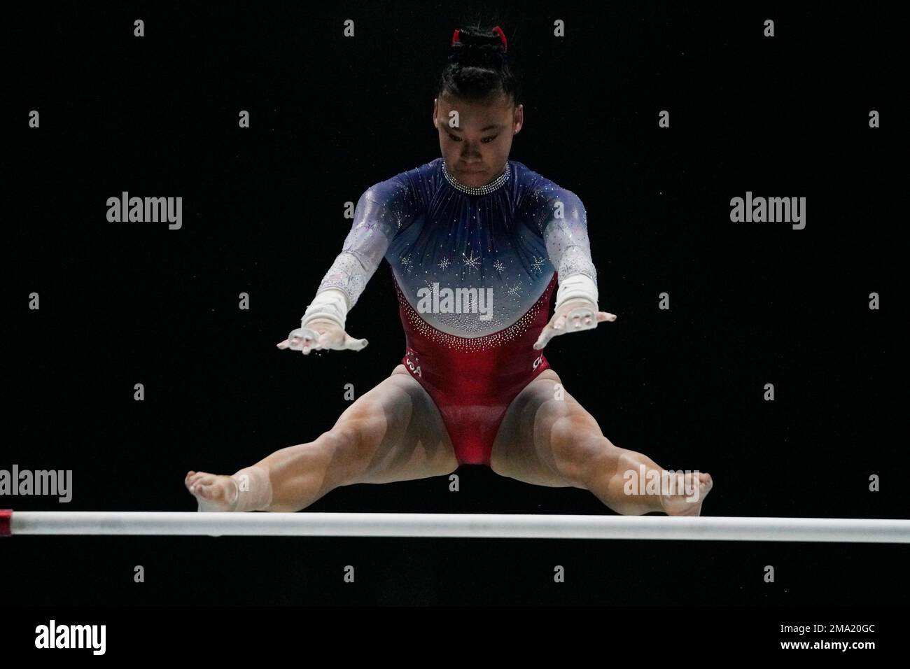 Leanne Wong of the U.S. competes on the uneven bars at the Women's Team ...