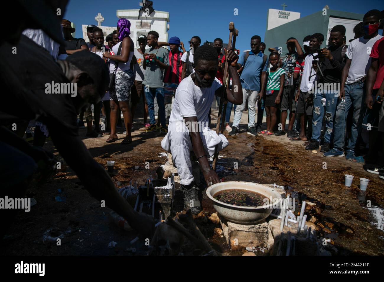 People perform a ritual at an altar during the annual Vodou festival at ...