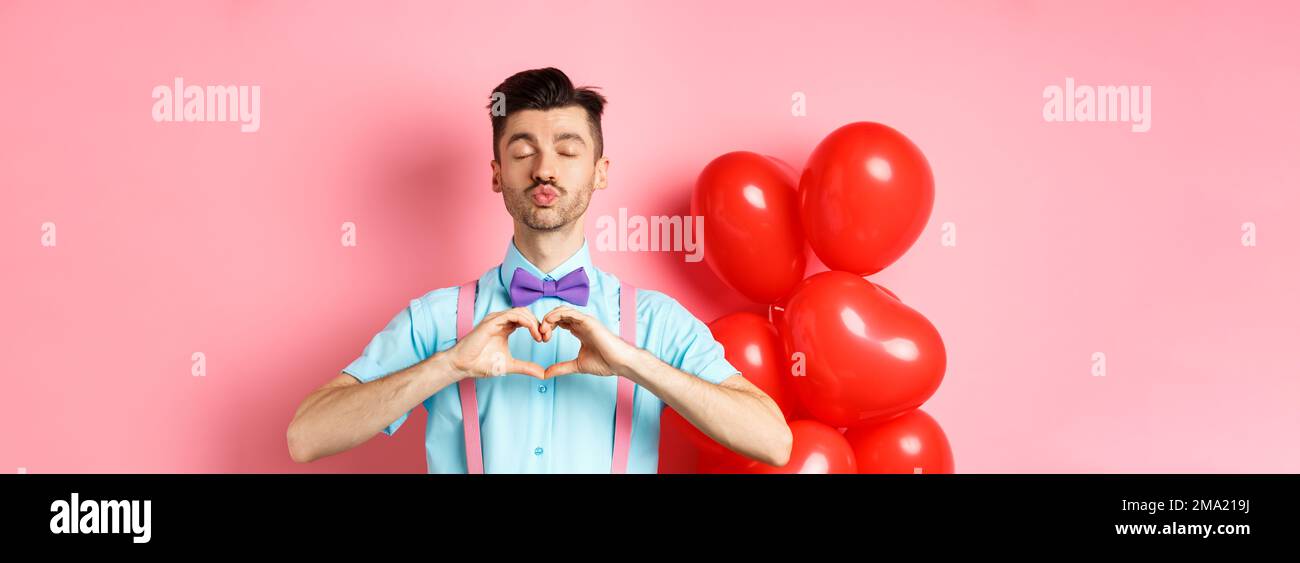 Valentines day concept. Passionate guy showing kissing face and heart ...