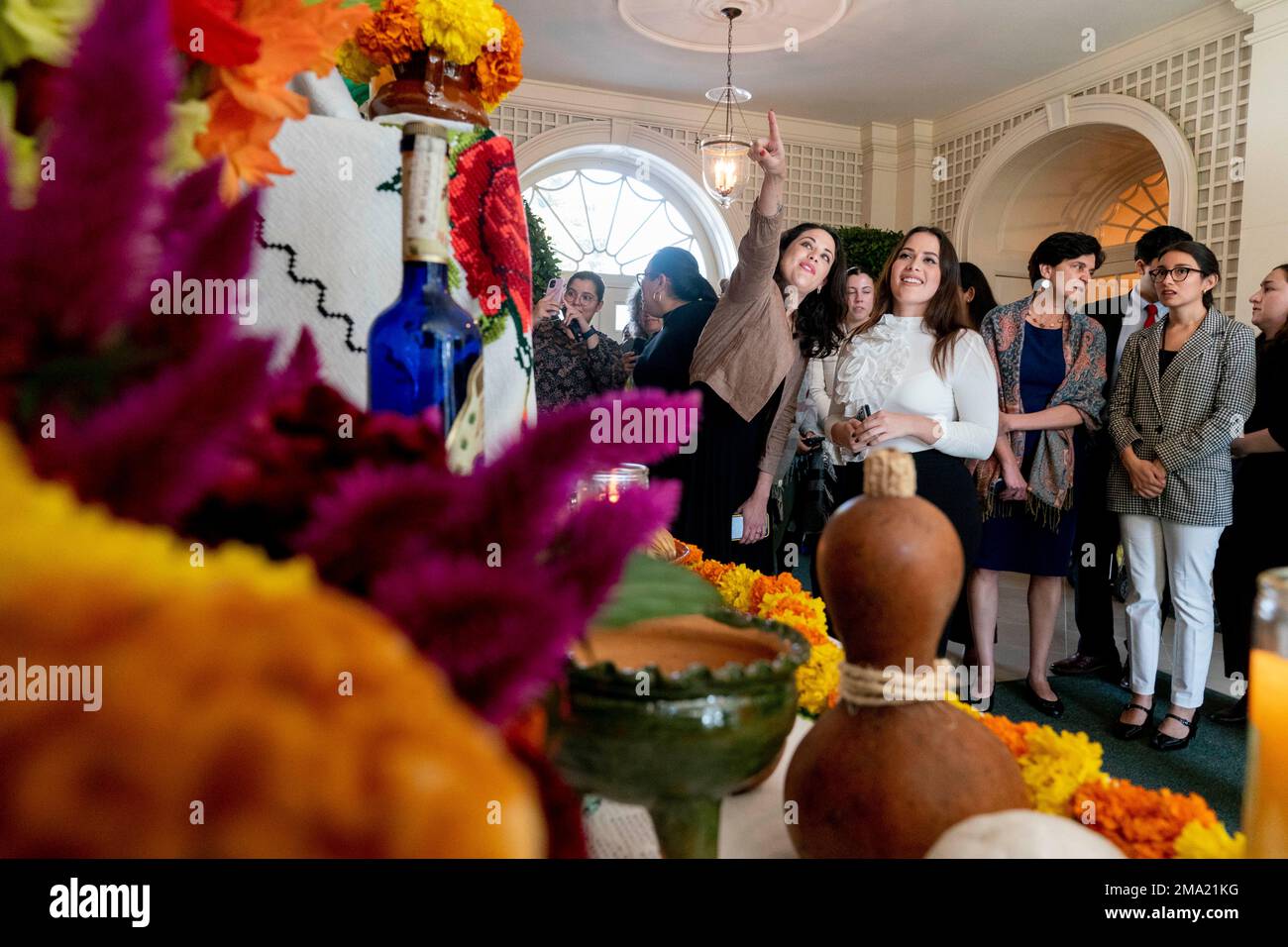 White House staff look at an ofrenda to celebrate Dia De Los Muertos ...