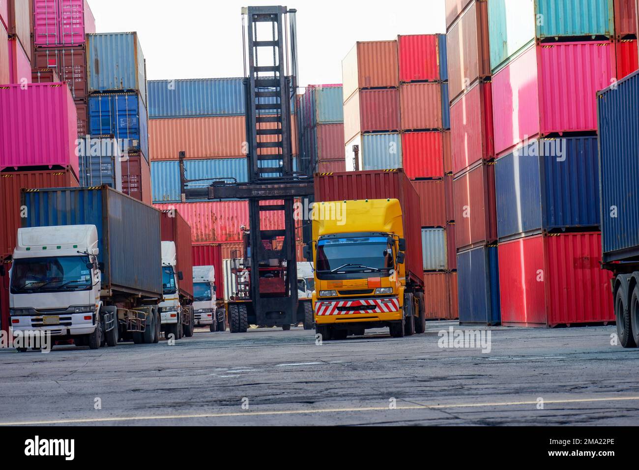 Container forklifts and trucks in the container yard Focus on imports ...