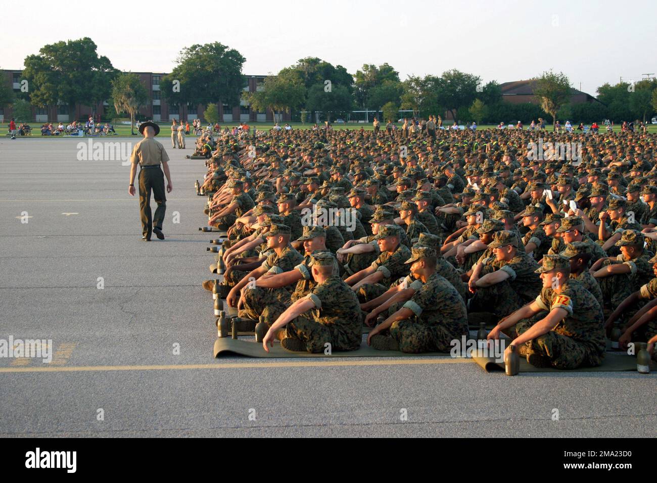 A US Marine Corps (USMC) male Drill Instructor (DI) inspects the ...