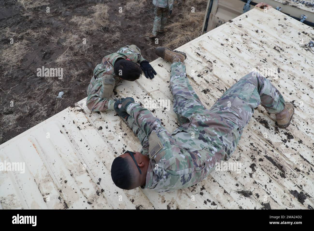 Soldiers at Fort Carson, Colorado help each other climb a container ...
