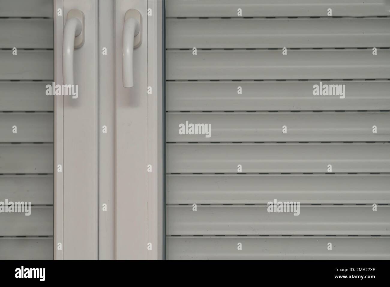 window blinds and close-up, double-leaf white plastic window, two window handles Stock Photo - Alamy