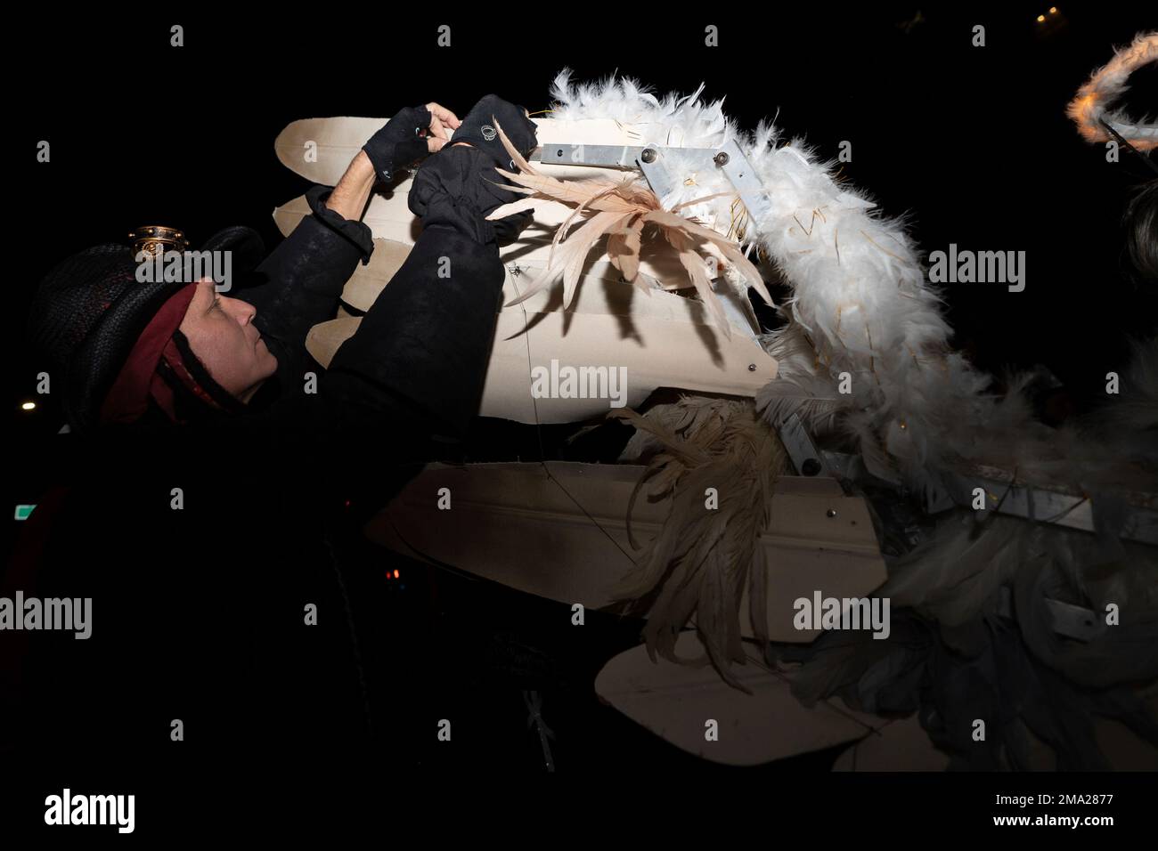 A reveler dressed as Jack Sparrow fixes an angel wing during the ...