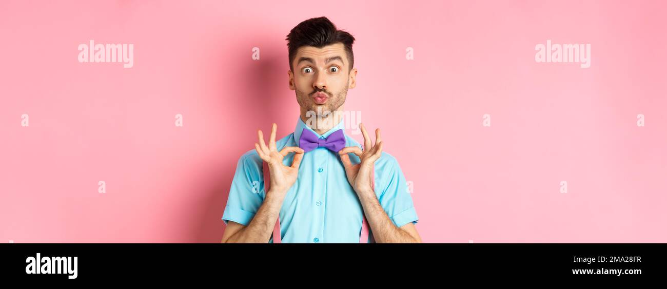 Handsome and funny young man pucker lips for kiss, showing his classy ...