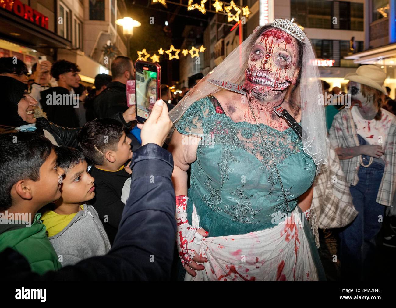 People dressed up in scary costumes participate in the annual Zombie ...