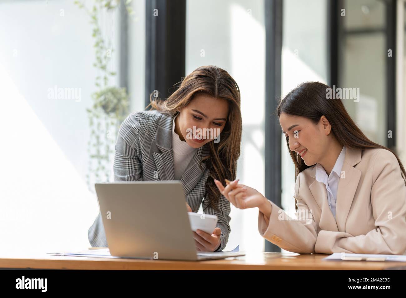 Young colleagues discuss business and analytical price charts using ...