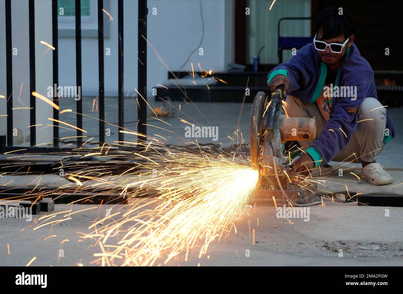 A worker fabricates a roof at a construction site in Sre Ampel village ...