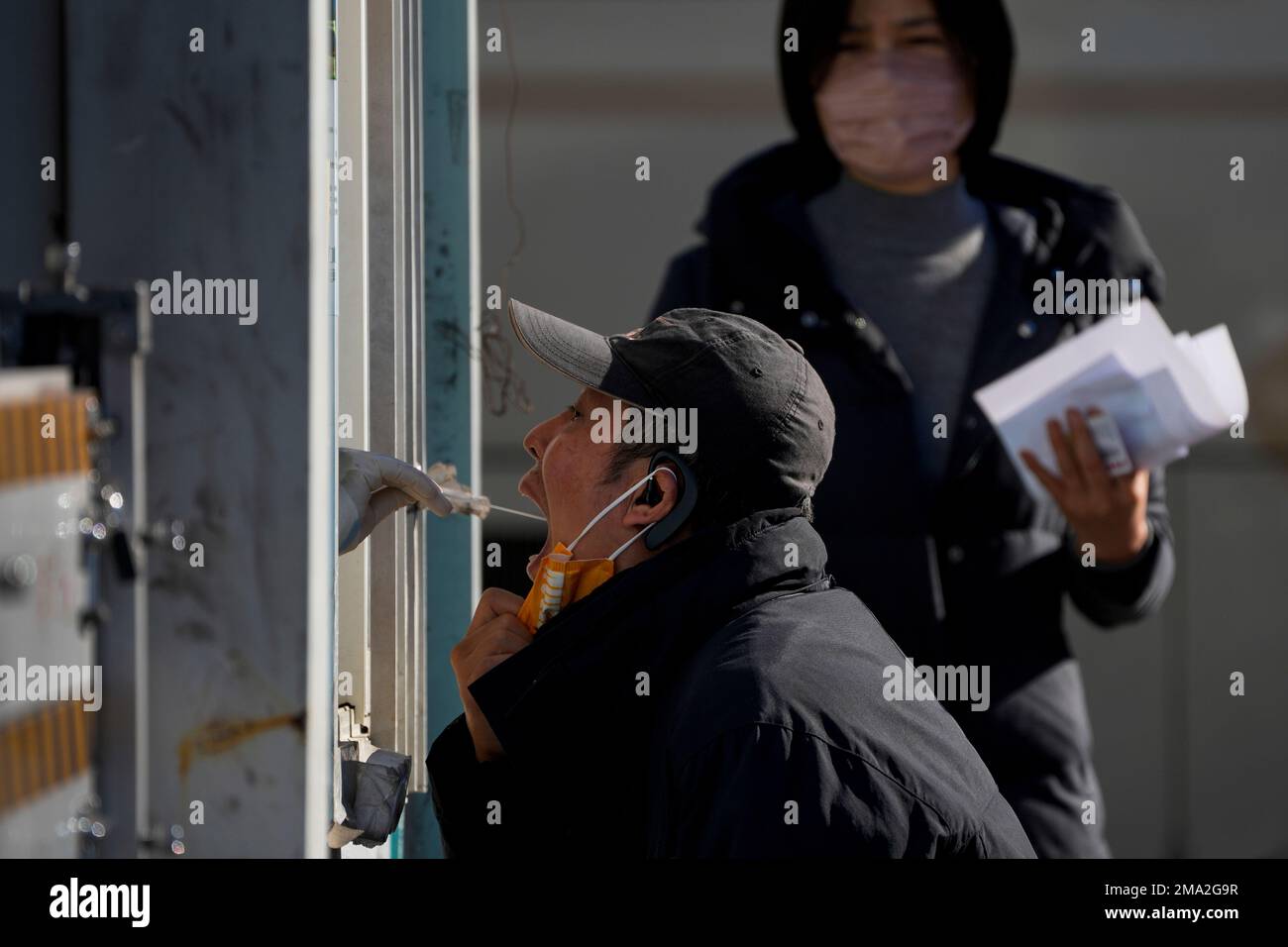 A man gets his routine COVID-19 throat swabs at a coronavirus testing ...