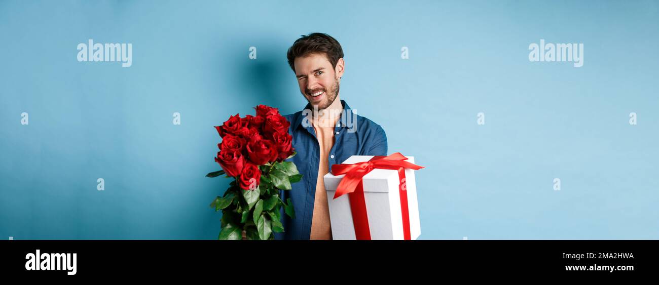 Love and Valentines day concept. Happy guy winking and smiling at ...