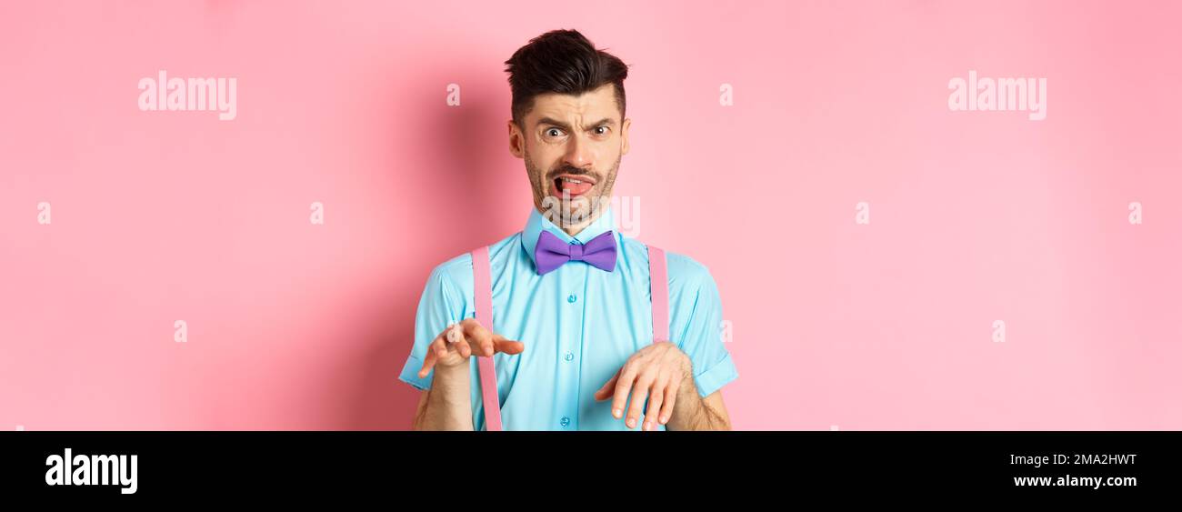 Funny guy looking at something disgusting with aversion and cringe ...