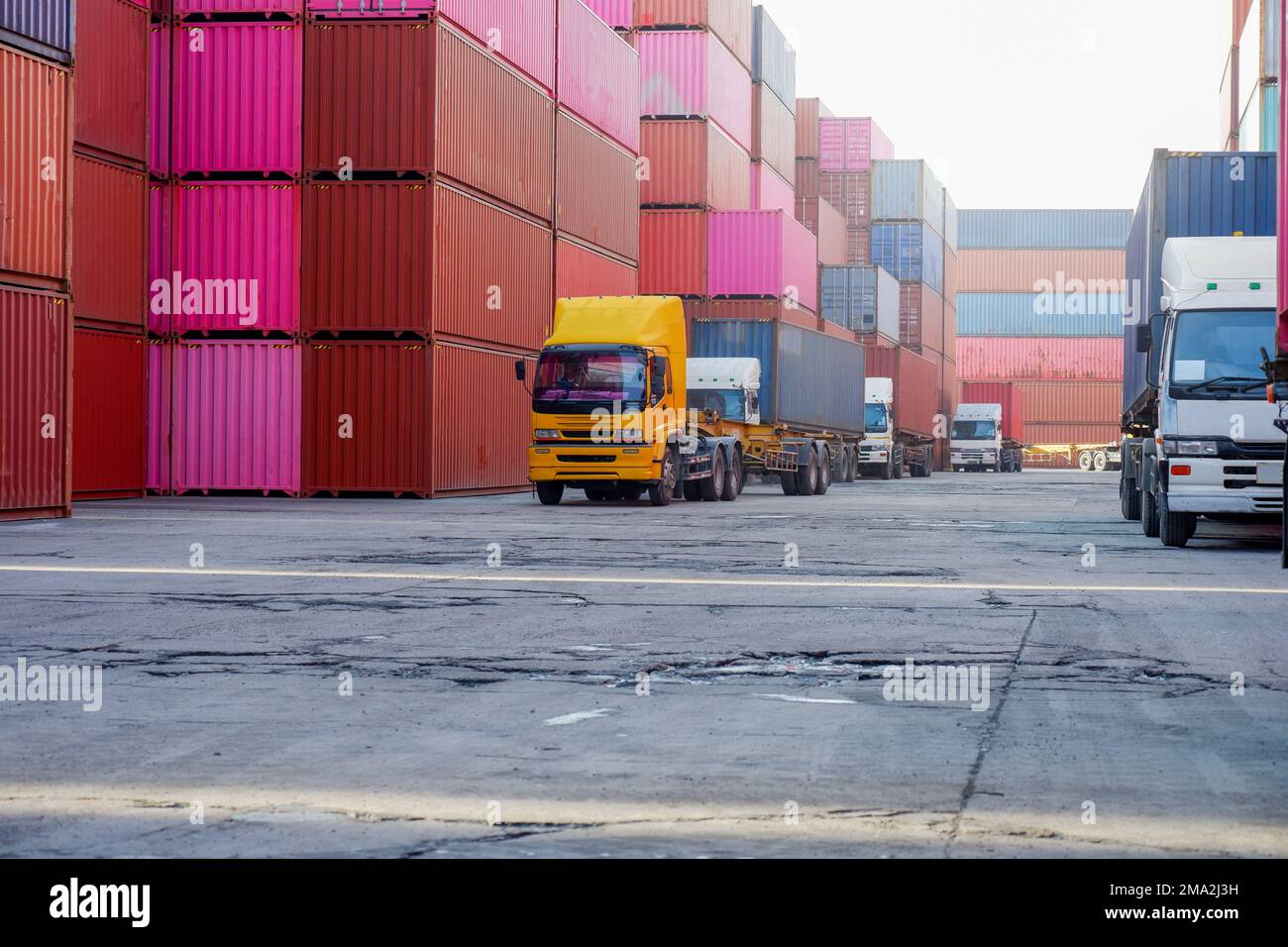 Trucks in the container yard Stock Photo - Alamy